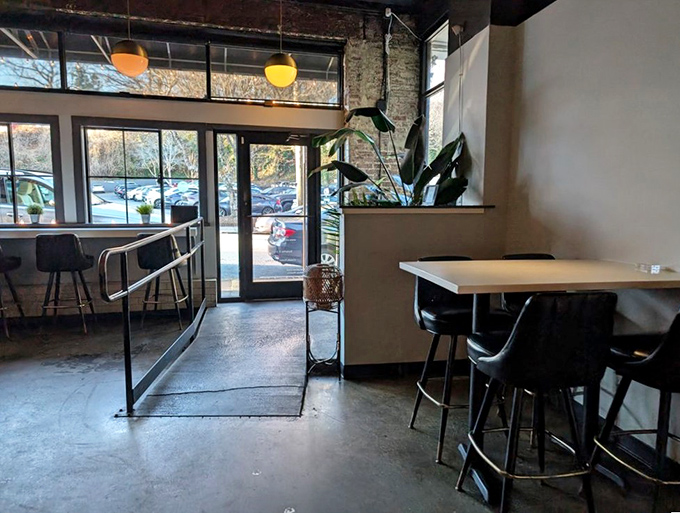 Natural light floods the entrance, creating a welcoming transition between Atlanta's bustling streets and Whiskey Bird's tranquil dining experience.