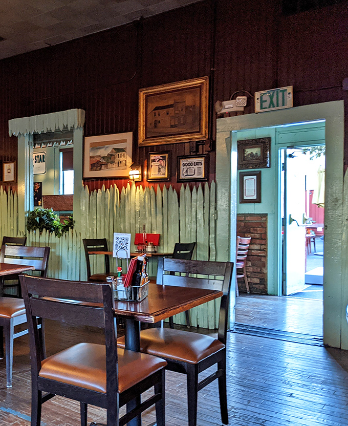 The exit doorway framed by mint-green pickets and decades of history&mdash;a portal between everyday life and a timeless dining experience.