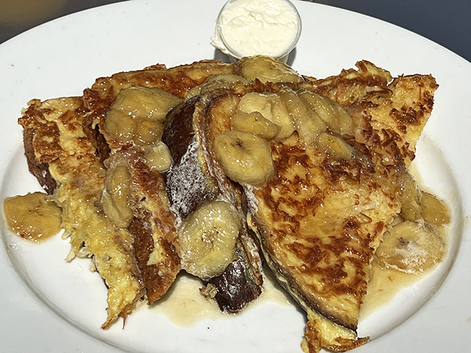French toast that achieves the perfect balance between crispy edges and custardy centers, topped with caramelized bananas.