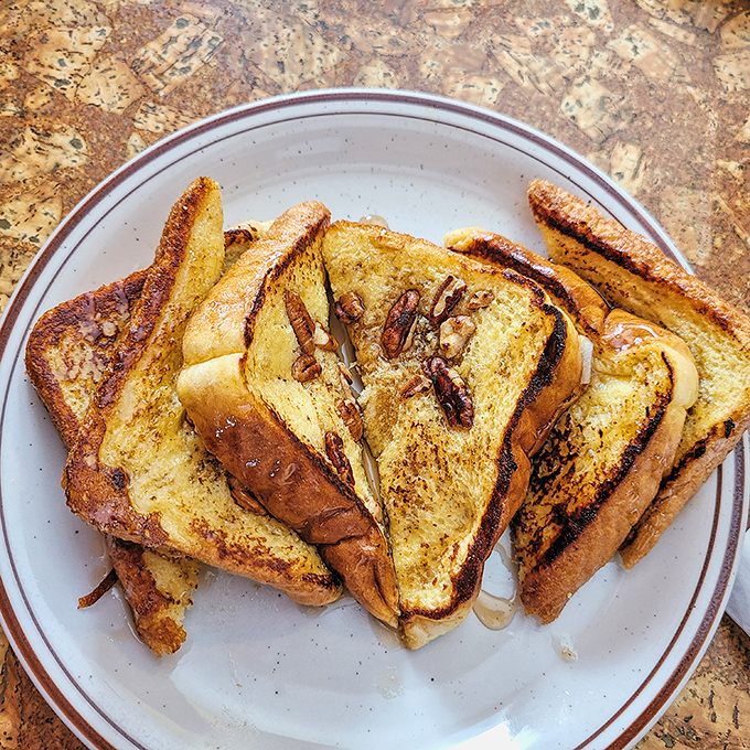 French toast with pecans and maple syrup that makes you understand why people willingly wake up before 9am on weekends.