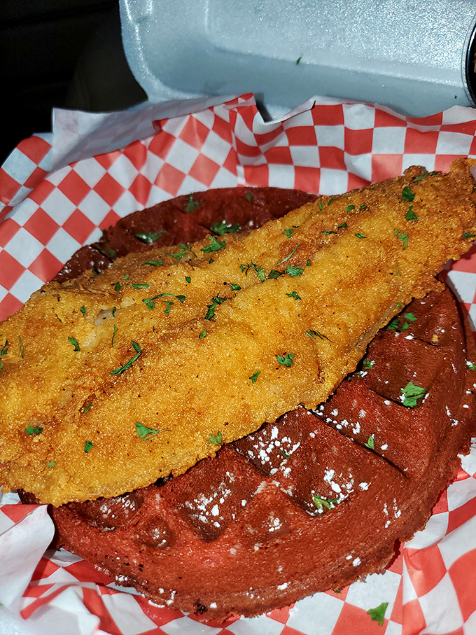 Whoever paired crispy fish with a red velvet waffle deserves a culinary Nobel Prize. It's breakfast meets dinner in a combination that shouldn't work but absolutely does.
