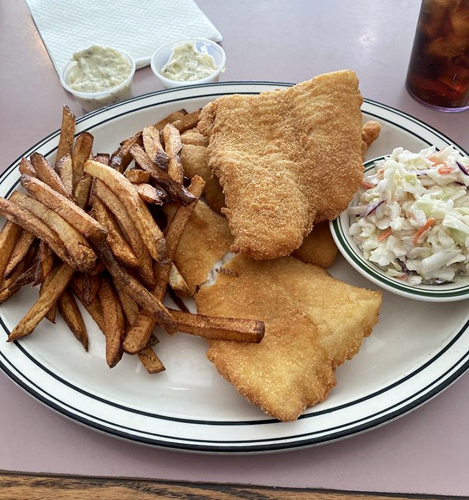 Fried fish that's wearing its golden-brown coat with pride. The coleslaw isn't just a side&mdash;it's the refreshing counterpoint in this crunchy symphony.