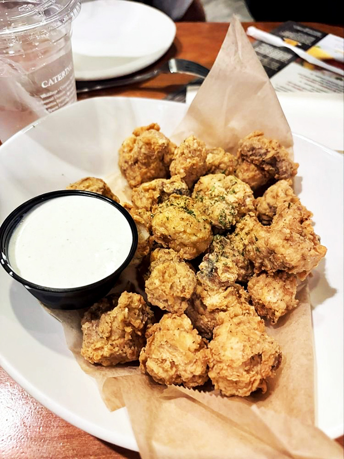 Fried mushrooms that crunch louder than your diet plan being torn up. That dipping sauce is basically a supporting actor deserving its own award.