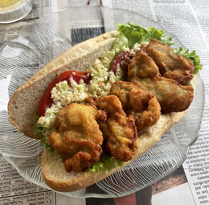 This fried oyster sandwich isn't just lunch&mdash;it's a masterpiece of textures: crispy coating, tender oysters, cool slaw, and soft bread in perfect harmony.