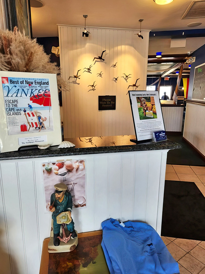 A welcoming entrance adorned with flying seabirds—your first hint that this place soars above ordinary seafood joints.