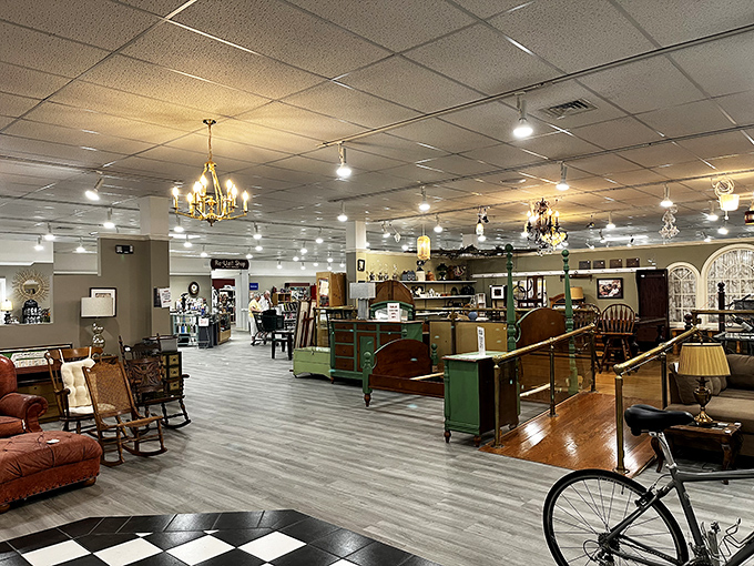 Chandeliers illuminate furniture arranged like an eccentric millionaire's estate sale. That green desk has stories to tell.
