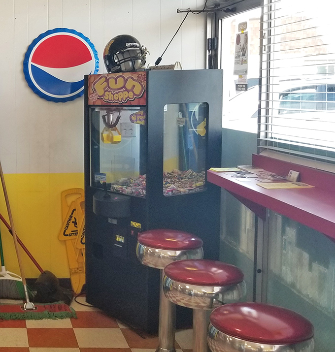 Three little stools and a claw machine&mdash;the perfect distraction while you contemplate ordering just one more hot dog.