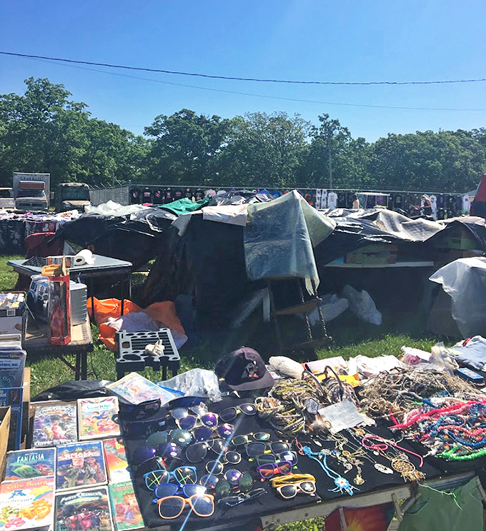 Sunglasses and trinkets spread like confetti. One person's "too much" is another's "just what I was looking for" in the flea market universe. 