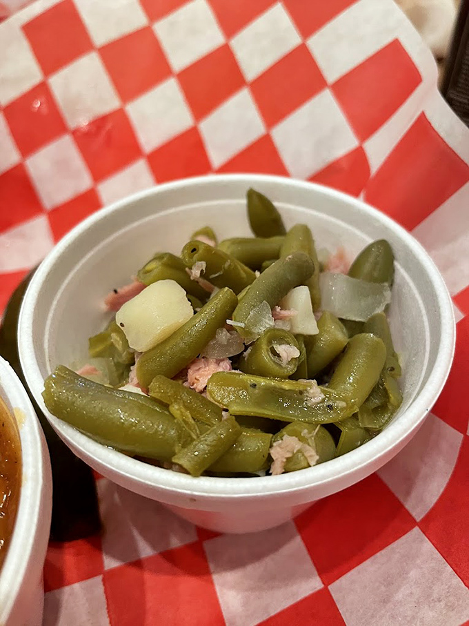 Green beans that have clearly been hanging out with pork. Not your grandmother's vegetable side—unless your grandmother was a pitmaster.