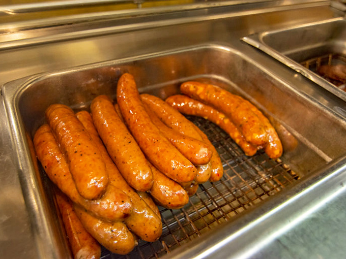 Sausages glistening with promise in their hot bath&mdash;the unsung heroes of any respectable barbecue spread.