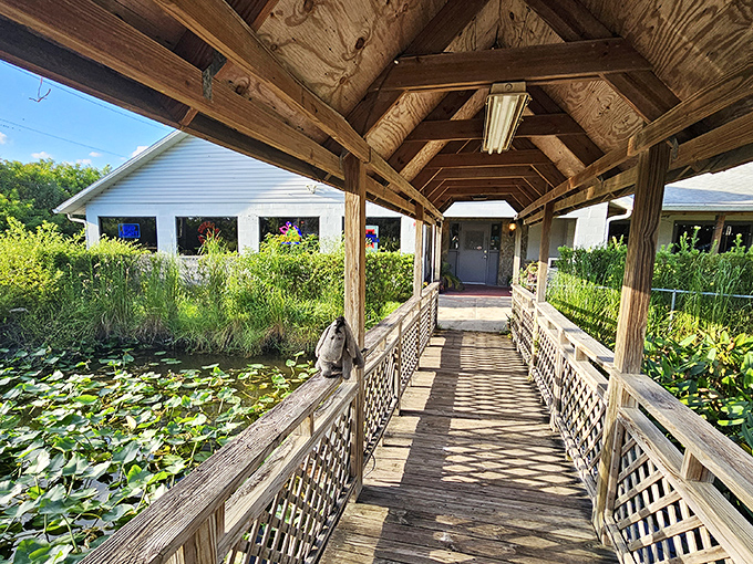 The covered walkway over a lily pond adds unexpected charm. Like finding poetry in a steakhouse, this entrance path sets the stage for culinary drama.