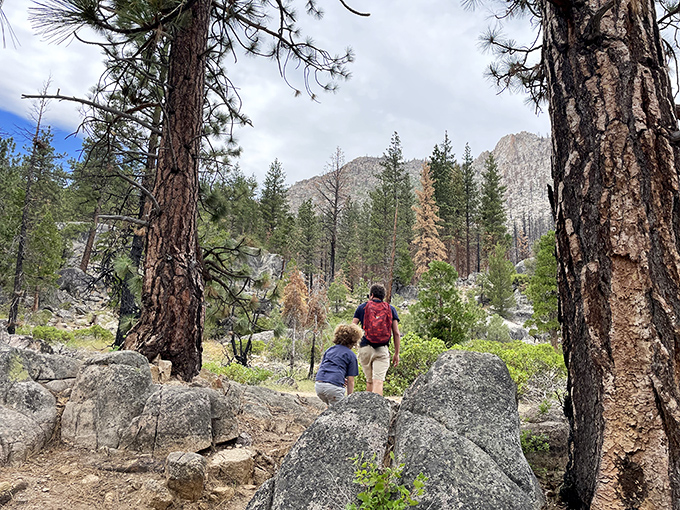 Hikers navigate granite-studded trails, where every turn offers a new perspective on the Sierra's rugged beauty.