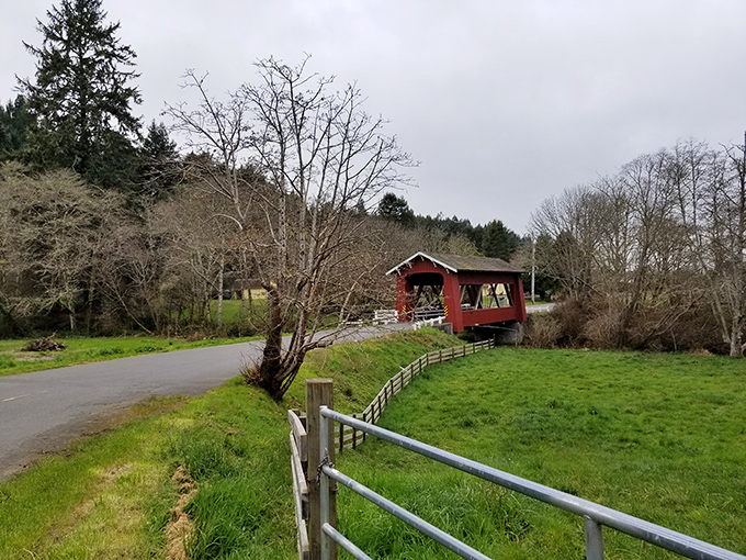From this vantage point, the bridge appears as a rustic painting against the landscape&mdash;a splash of heritage red amid rolling hills and greenery.
