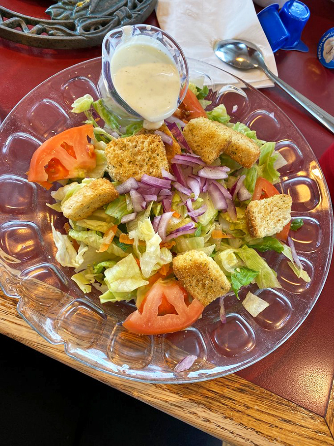 A house salad that politely reminds you vegetables exist, while the dressing whispers, "Don't worry, we'll make this worth your while."