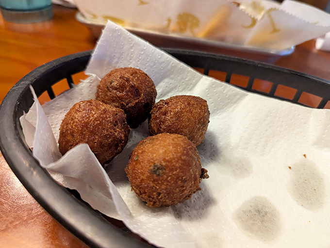 Hushpuppies so perfectly golden they deserve their own trophy. Crispy outside, fluffy inside&mdash;the unsung heroes of the seafood feast. 