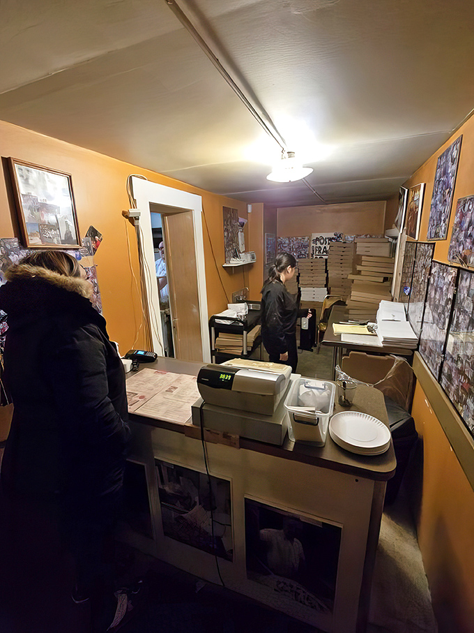 Behind the scenes where pizza dreams come true. The stacks of boxes stand ready for another day of feeding the faithful their tomato pie fix.
