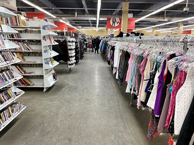 Books and blouses coexist in perfect harmony, proving that Value Village's organization system is somehow both chaotic and brilliant.