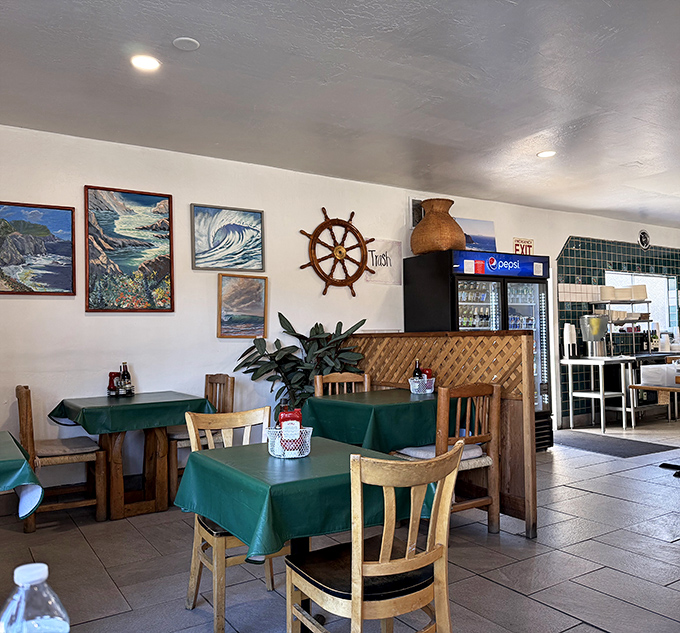The interior walls showcase maritime art that wasn't bought in bulk. That ship's wheel has probably seen more authentic seafood than most food critics.