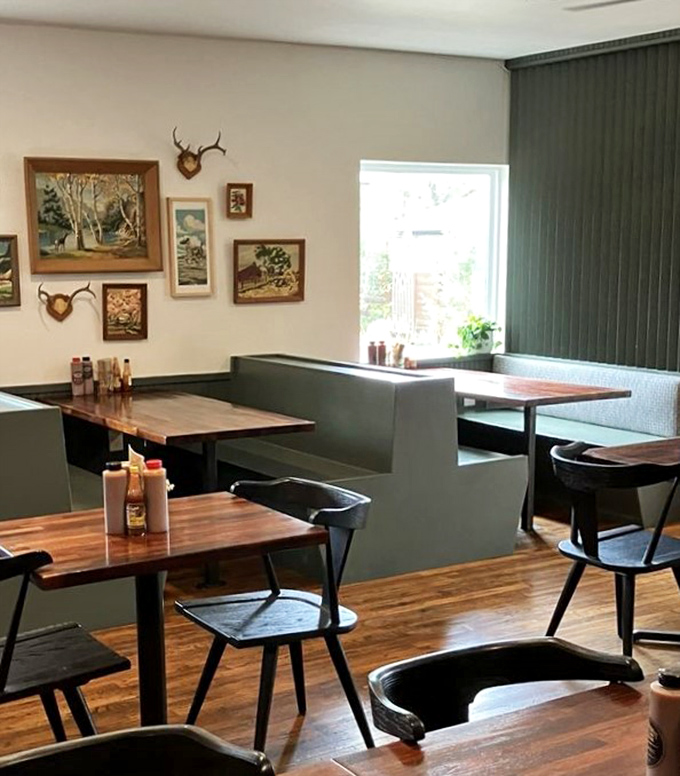 Booths designed for serious eating business. The vintage paintings say "we respect tradition" while the menu whispers "but we're not afraid to innovate."