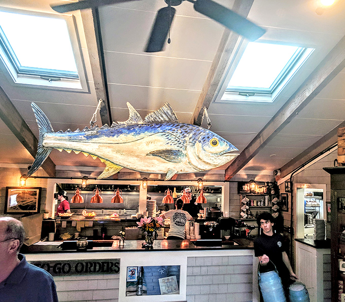 That giant fish watching over the kitchen is basically saying, "Yes, we know what we're doing with seafood." The open kitchen proves they have nothing to hide.
