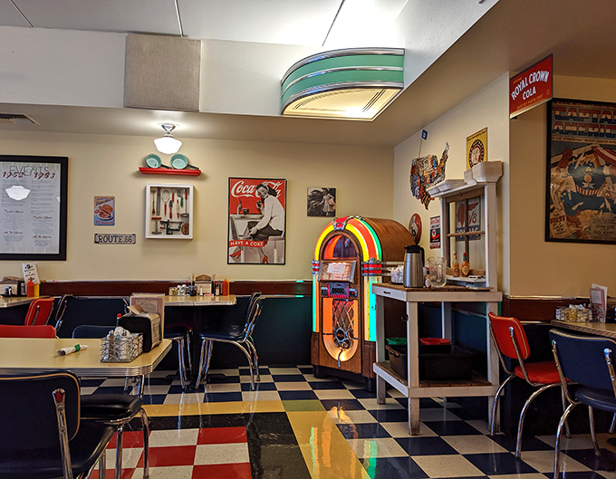 The jukebox glows with neon promise, ready to soundtrack your meal with hits from simpler times.