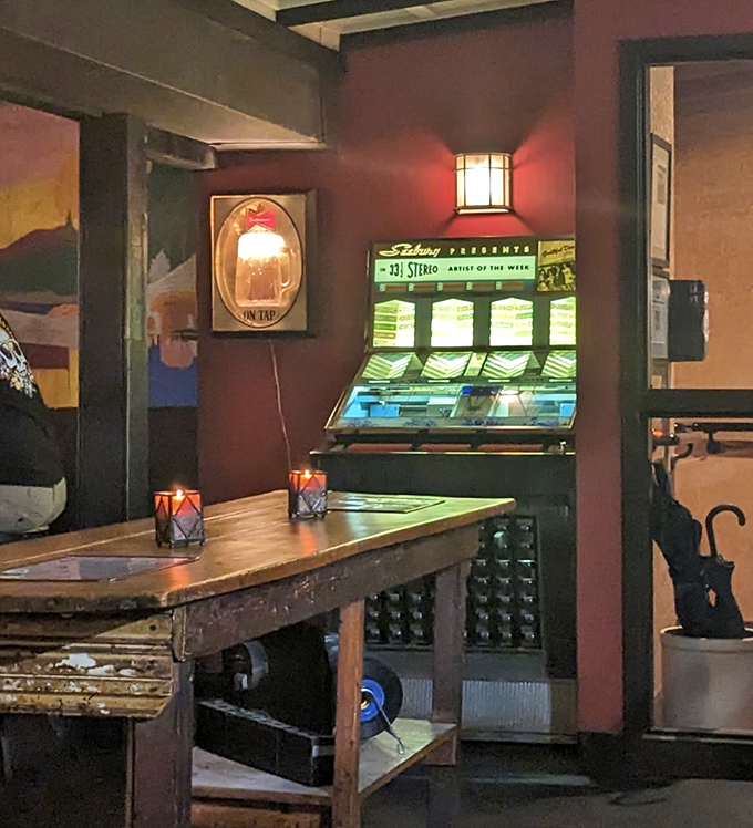 A vintage jukebox stands ready to provide the soundtrack to your meal, proving some technologies never go out of style.