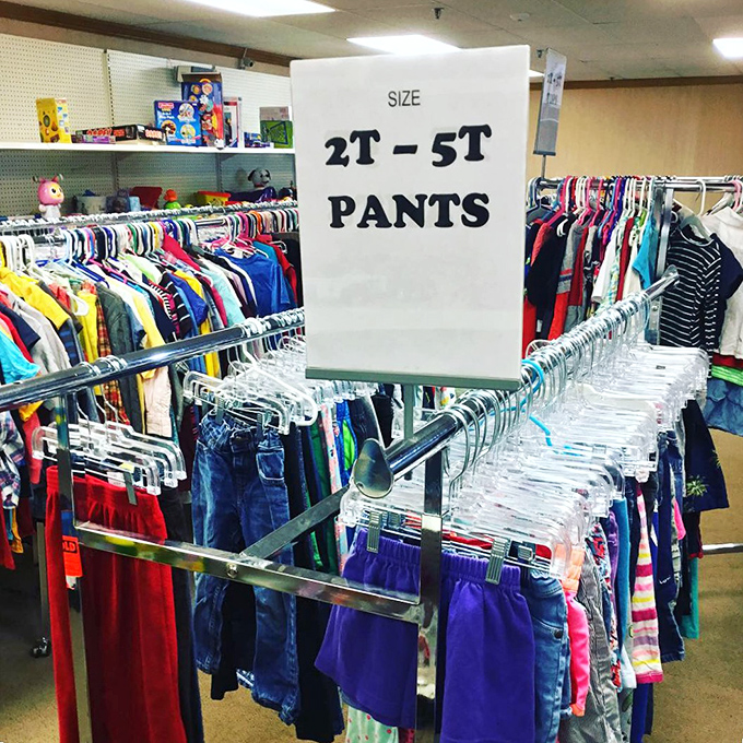 Organized chaos at its finest: children's clothing sorted by size, where growing kids can get entire wardrobes without growing the credit card bill.