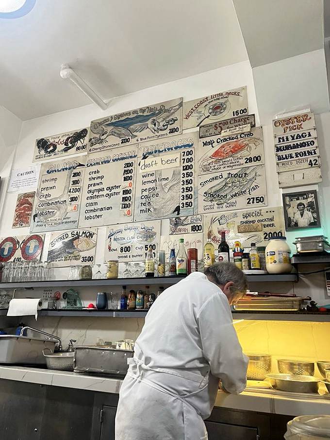 Where the seafood sorcery happens &ndash; white-aproned wizards transforming the ocean's bounty into memorable meals with practiced precision.