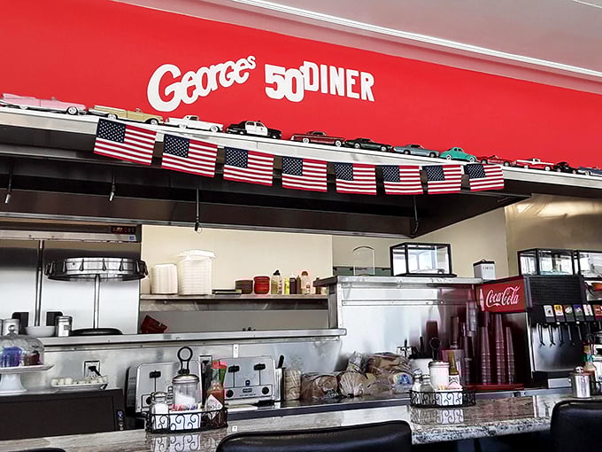 The open kitchen area, where American flags and classic car models remind you that diners are as patriotic as apple pie and twice as satisfying.