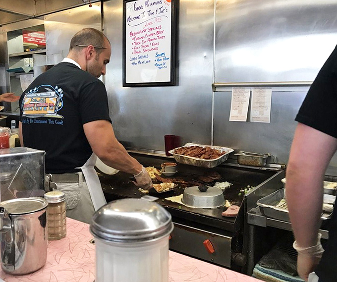 The kitchen ballet&mdash;where short-order cooks perform the choreography of breakfast with the precision of dancers and the timing of comedians.