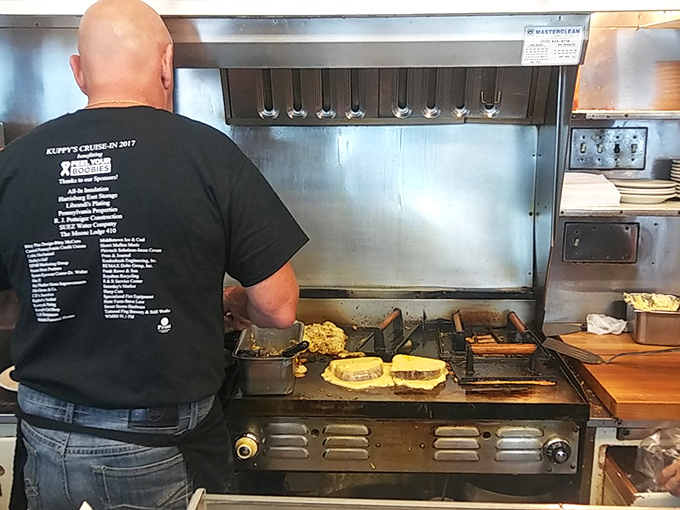 The heart of any great diner&mdash;a cook at the flat-top grill, orchestrating a symphony of sizzles and creating breakfast magic with practiced hands and perfect timing.