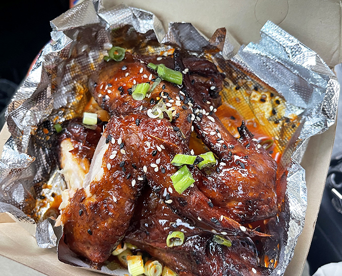 Korean-style wings glistening with sweet-spicy glaze and green onions &ndash; proof that barbecue transcends borders and speaks a universal language.