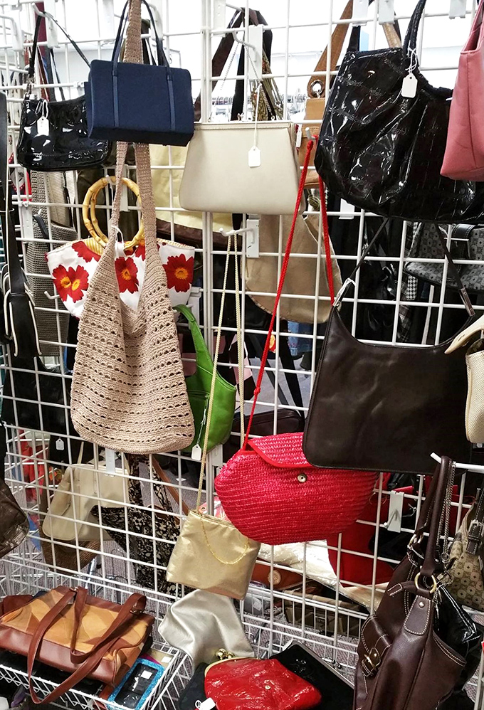 Handbag heaven hanging in suspended animation. That woven tote with red flowers is practically screaming "summer farmers market companion."