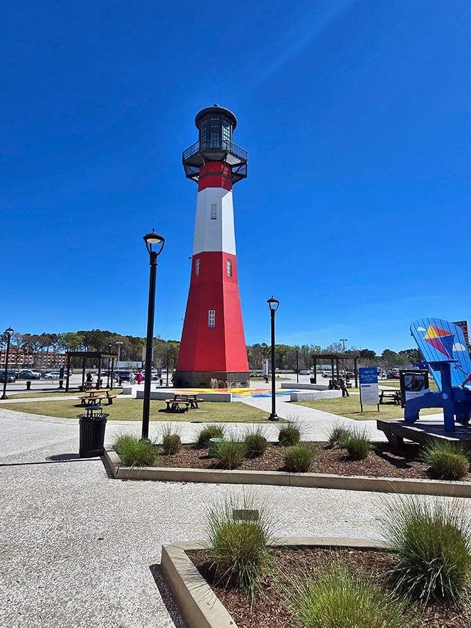 The lighthouse stands sentinel over the parking lot, a nautical-themed reminder that you've navigated your way to shopping nirvana.