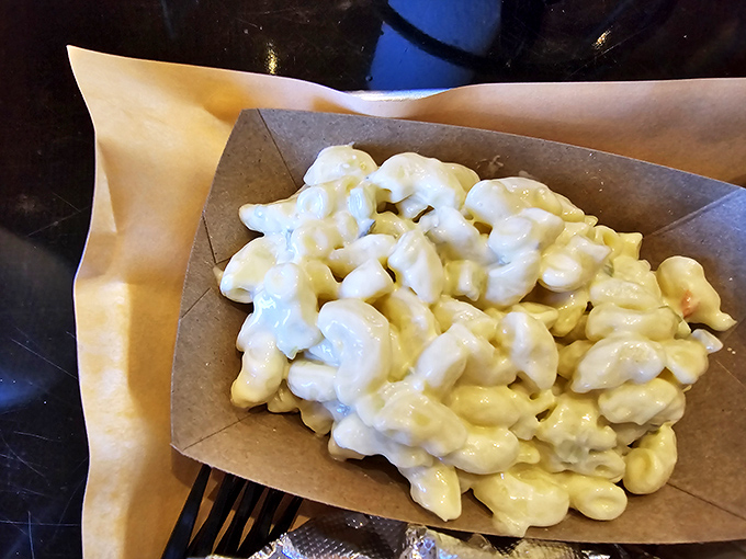 Mac and cheese so creamy it should be illegal, served in a paper boat because fancy plates would just get in the way.