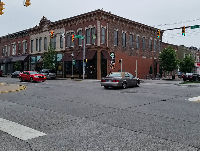 The intersection of small-town charm and modern convenience, where historic buildings house contemporary businesses under the watchful gaze of traffic lights.