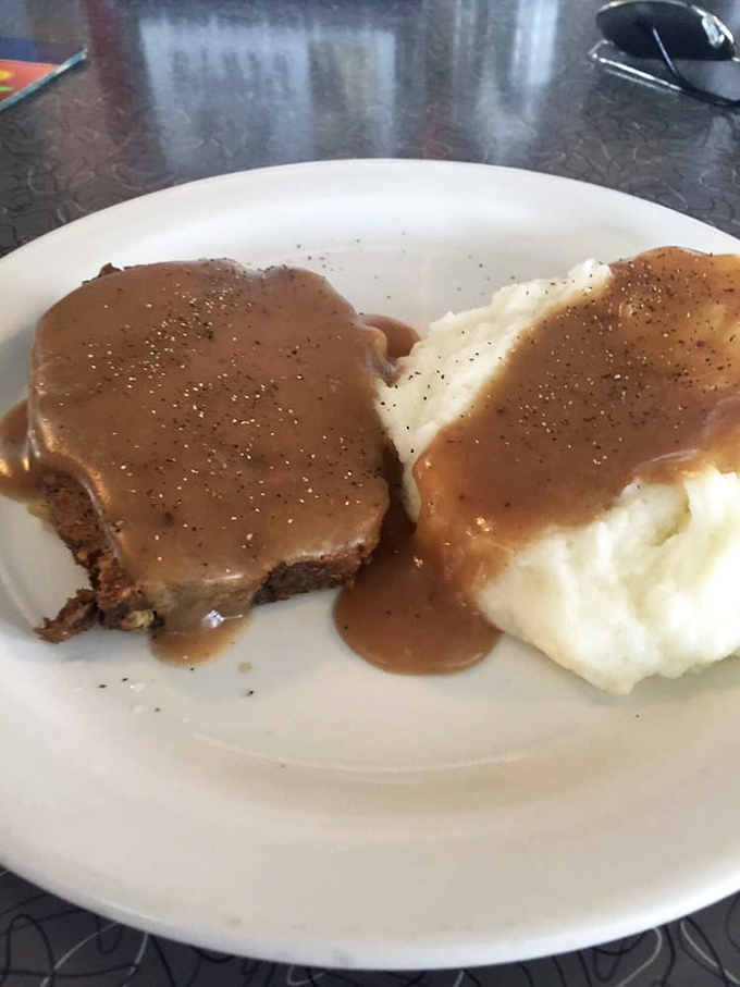 Meatloaf and mashed potatoes swimming in gravy – the kind of plate that makes you want to call your mother and apologize for ever complaining about dinner.