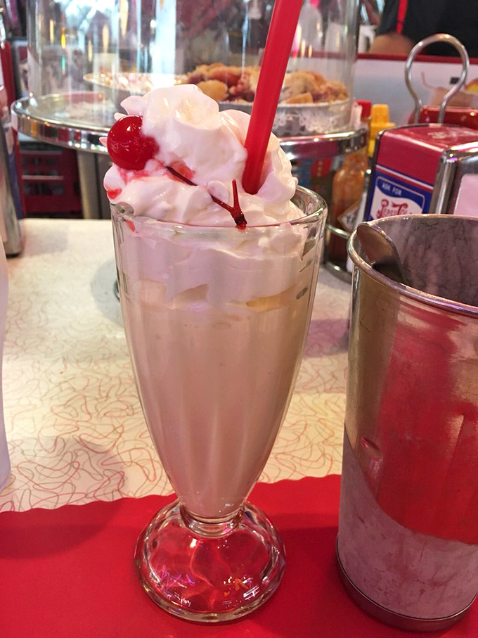 This milkshake brings all the joy to the yard&mdash;crowned with whipped cream and a cherry that's basically wearing a tiny dessert hat.