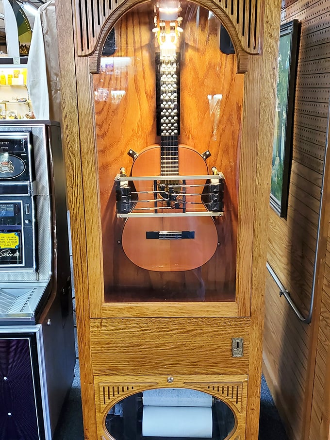 Not just a guitar display&mdash;a musical time capsule encased in golden oak. The strings may be silent, but the craftsmanship sings across generations.