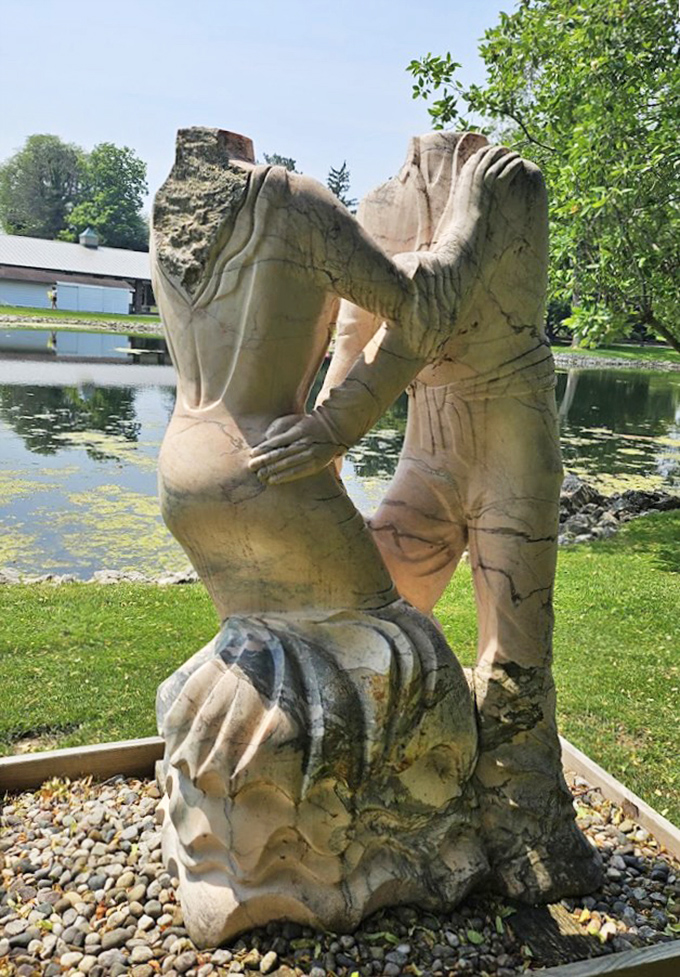 Love set in stone. This abstract sculpture captures the essence of connection&mdash;proving that even in a garden full of beauty, human bonds remain most captivating.
