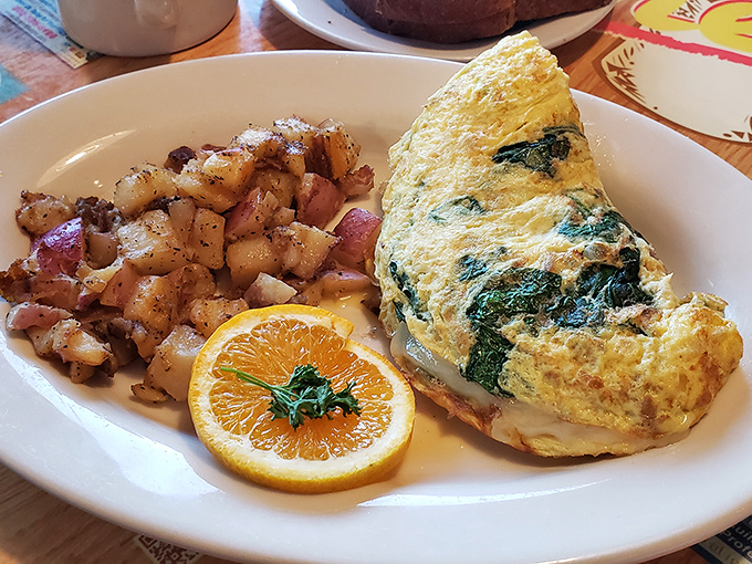 An omelet that actually contains more filling than egg&mdash;a rare and beautiful thing. Those seasoned potatoes aren't just a side, they're a statement.