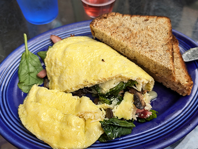 An omelet that's having an identity crisis as a work of art, stuffed with enough fillings to make breakfast last until dinner.