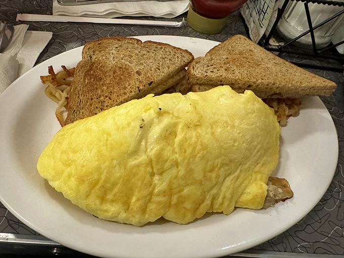 The omelet that ate Manhattan &ndash; fluffy, golden, and large enough to feed a small family, with perfectly toasted bread standing guard.