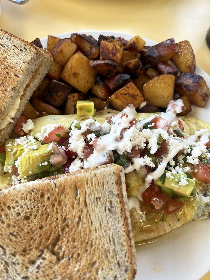 This isn't just an omelet&mdash;it's a vegetable delivery system disguised as breakfast, with home fries playing the perfect sidekick.