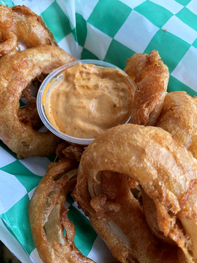 The legendary onion rings&mdash;golden halos of perfection with a dipping sauce that deserves its own fan club. Worth crossing state lines for.