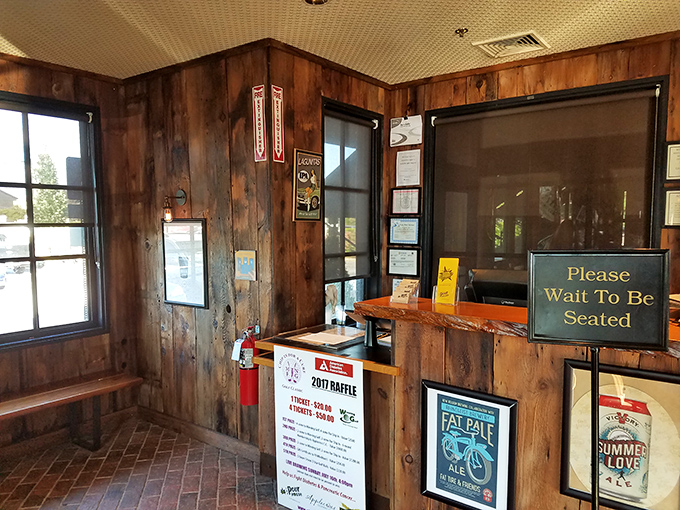 Rustic wooden walls and carefully curated beer signage create an entrance that feels both authentically vintage and perfectly contemporary.
