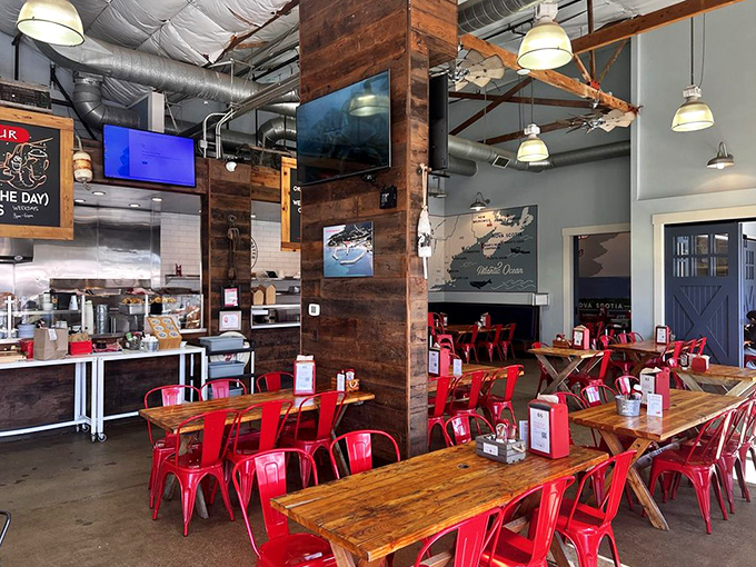 Industrial-chic meets maritime charm with wooden tables and those signature red chairs. Seafood tastes better with a side of atmosphere.