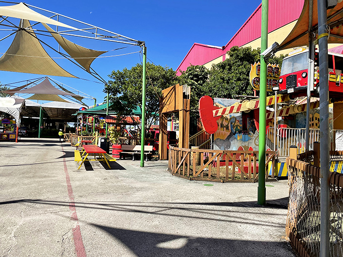 The outdoor section offers a respite from fluorescent lighting, with colorful storefronts creating a mini-Main Street vibe under the Florida sun.