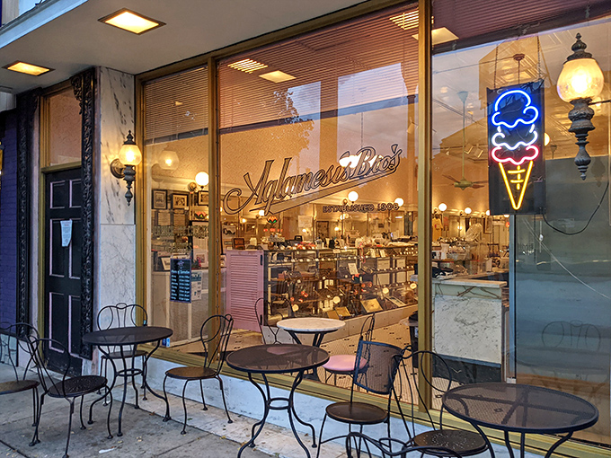 Sidewalk seating for those who can't wait to dive in. The neon ice cream cone sign glows like a beacon for dessert pilgrims.