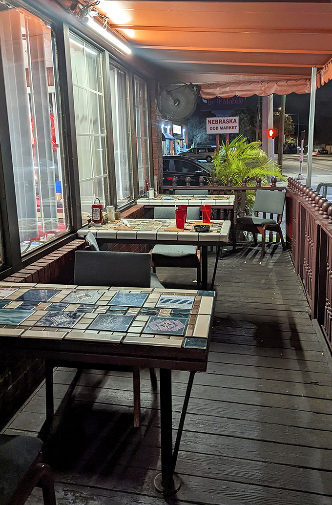 Outdoor seating with tile-top tables &ndash; where the Florida evening air mingles with the scent of coffee and possibility. Urban dining with neighborhood soul.